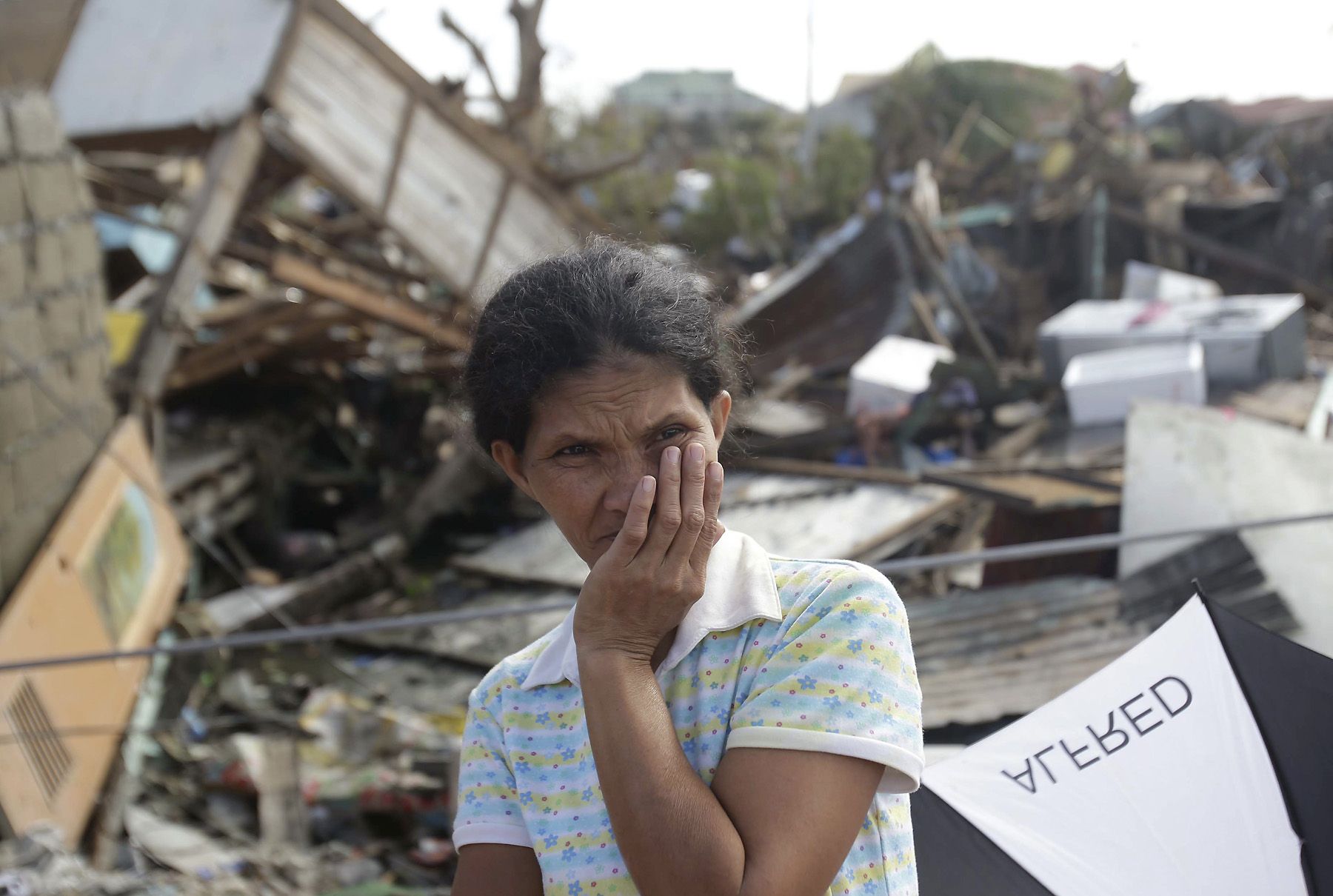 Survivor Stands Outside Home - Image 11 from A Look at the Typhoon ...